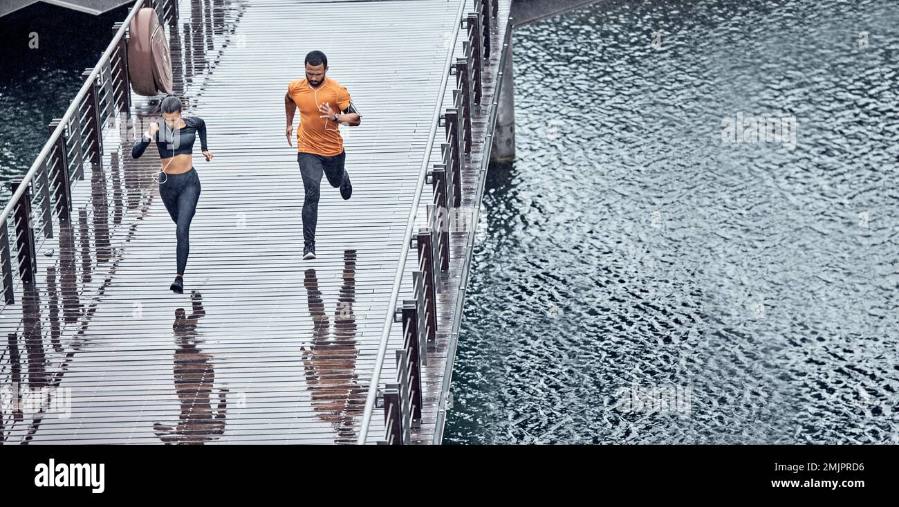 Overhead, fitness and man with woman running as exercise on city ...