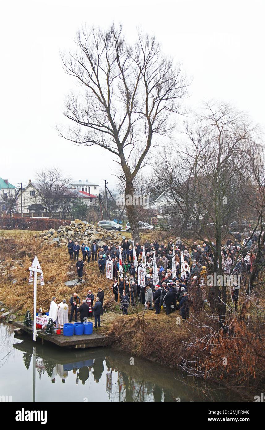 Two priests begin for the rite of Epiphany. Raven River in Tysmenytsia ...