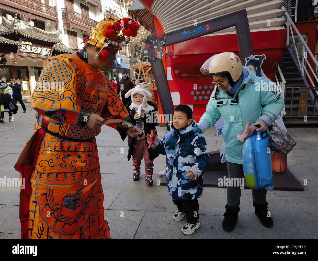 The God of Fortune, or caishen and a group of rabbits acted by children ...
