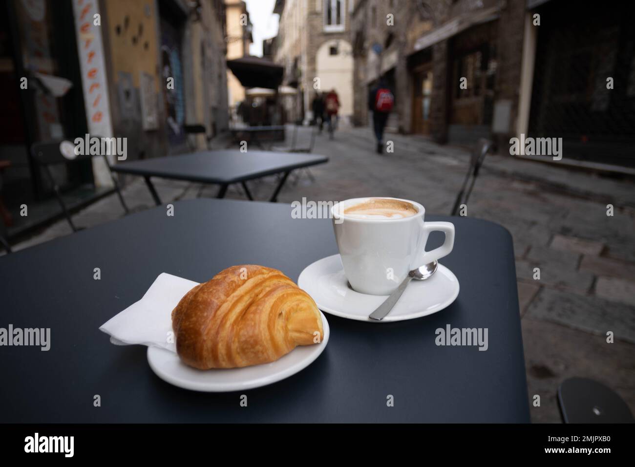 True Italian breakfast, Cappuccino coffee and a brioche on the street ...