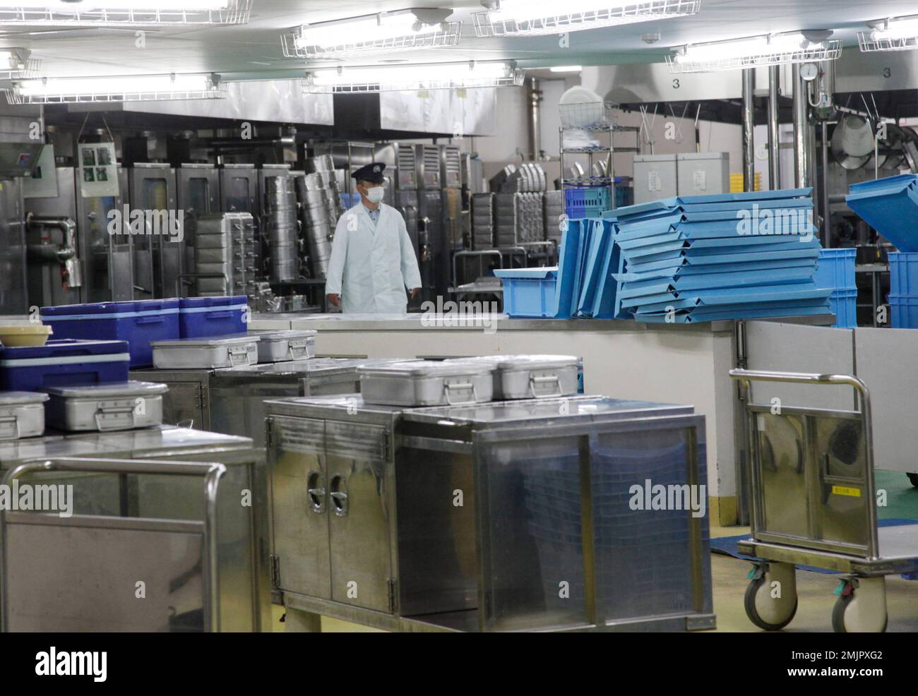 In this June 10, 2019, photo, a warden stands at a kitchen for inmates ...