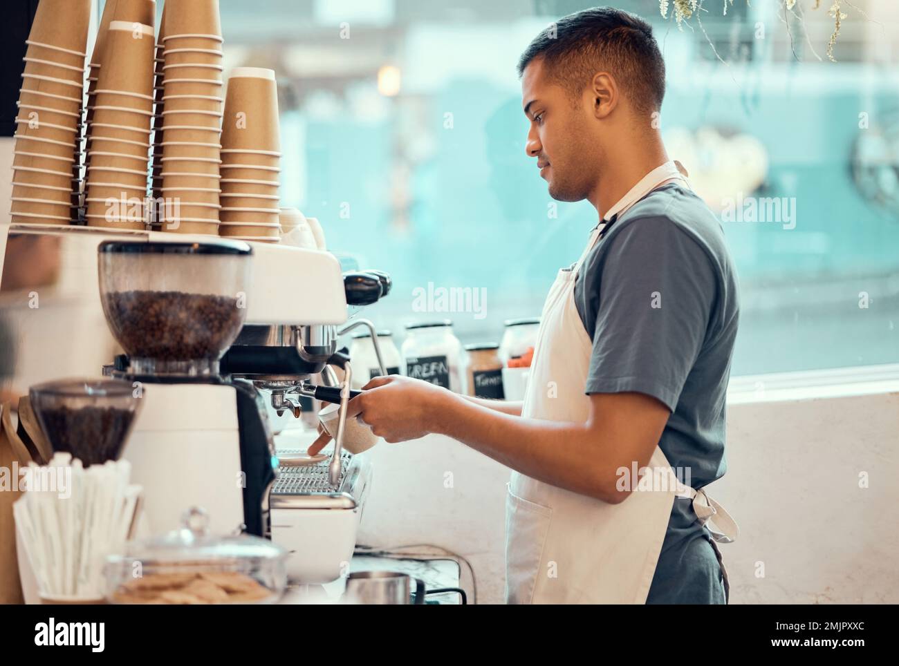 Cafe, coffee machine and man barista working on a espresso or latte ...