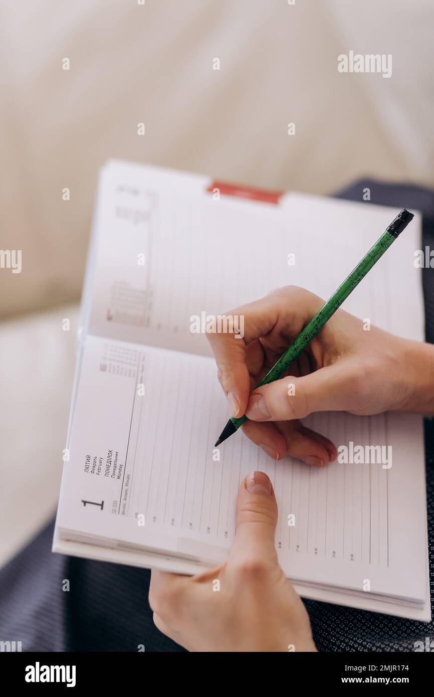 the girl's hands are writing in the diary Stock Photo - Alamy