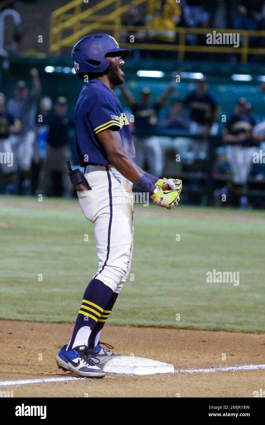 Michigan's Christan Bullock (5) celebrates on third base after he ...