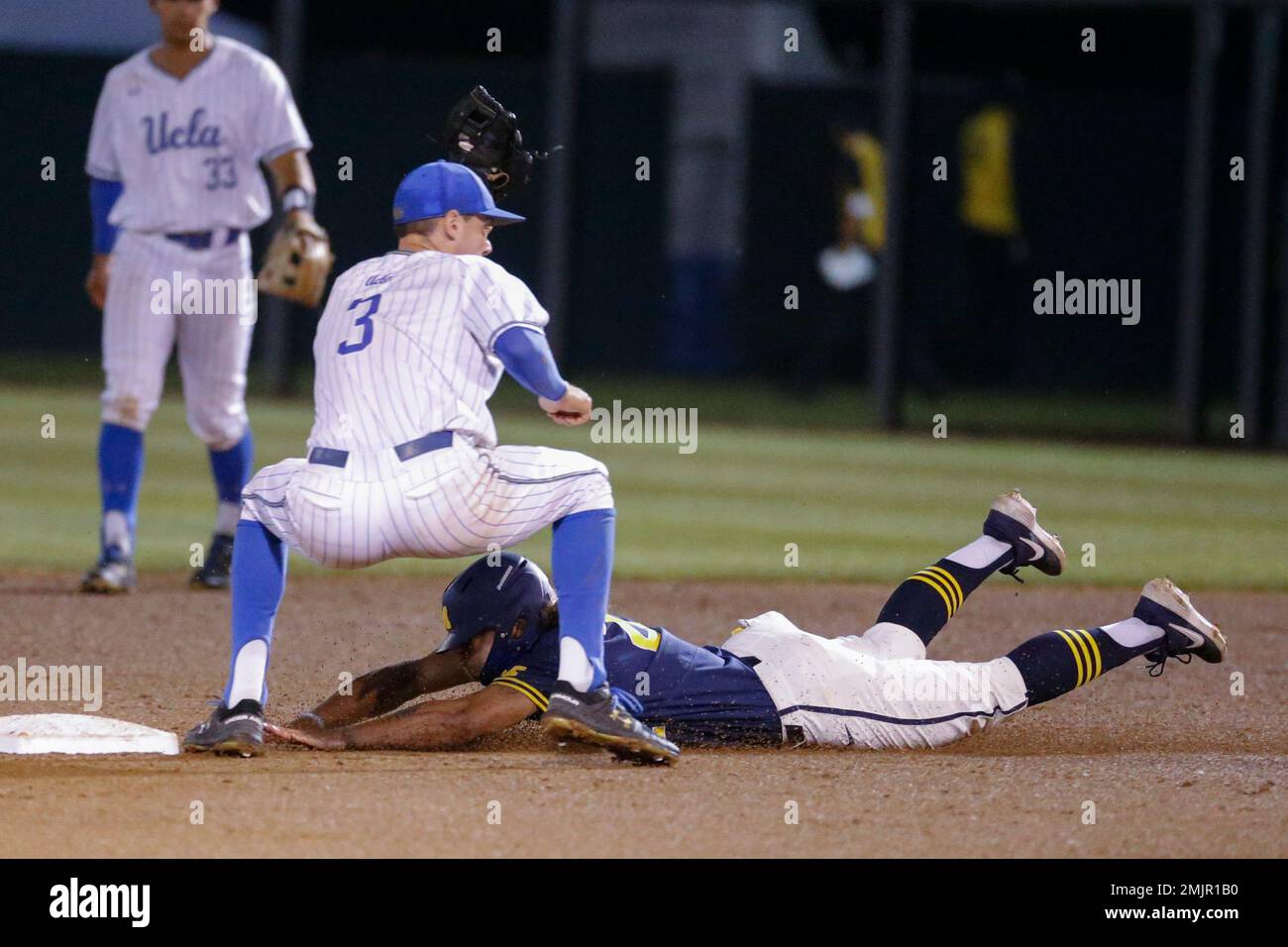 Michigan's Jordan Brewer (22) slides safely into second as UCLA's Ryan ...