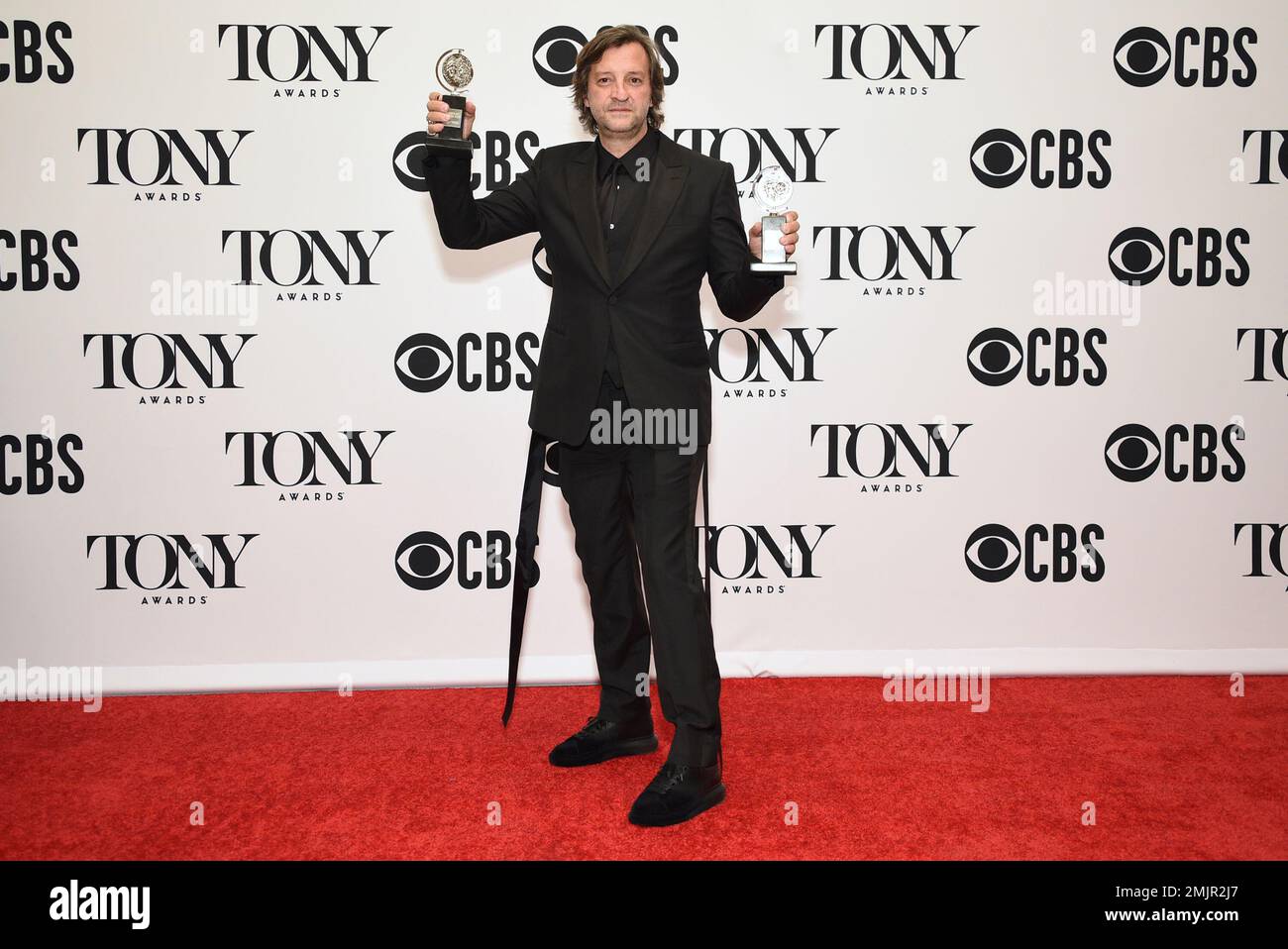 Rob Howell poses with the award for the best costume design of a play ...