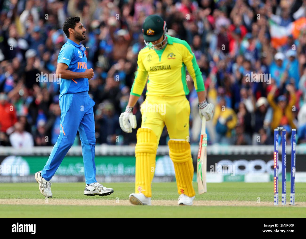 India's Bhuvneshwar Kumar, left, celebrates the dismissal of Australia ...