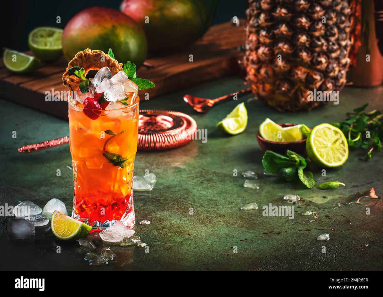 Alcoholic cocktail with vodka, pineapple juice, mango, red syrup and ...