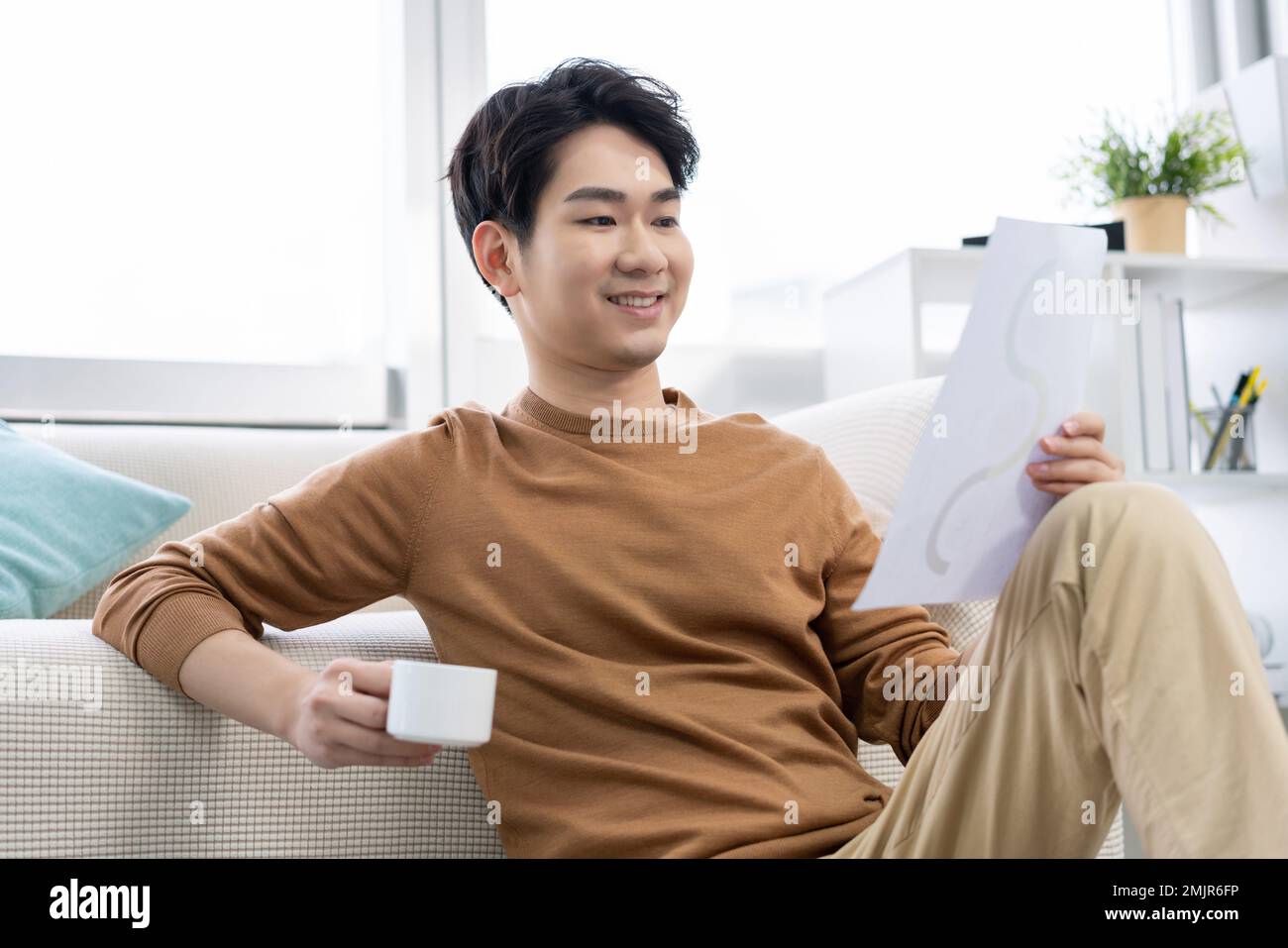 The young man look at files at home Stock Photo - Alamy