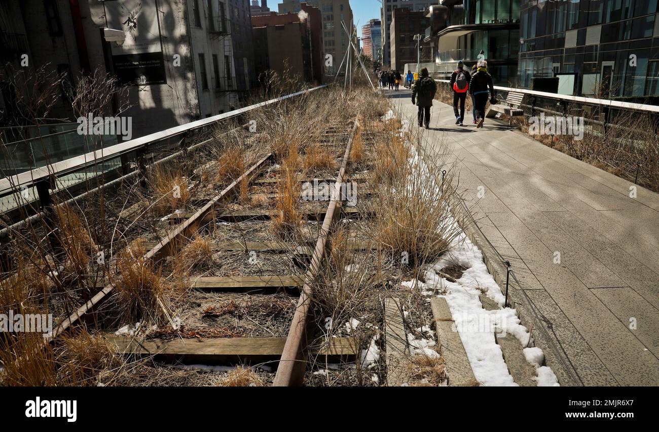 In this March 5, 2019 photo, exposed rail tracks run beside a walkway ...