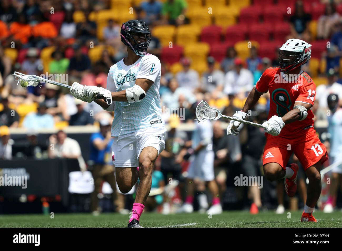 Chrome's Romar Dennis carries the ball as Whipsnakes' Ty Warner pursues ...