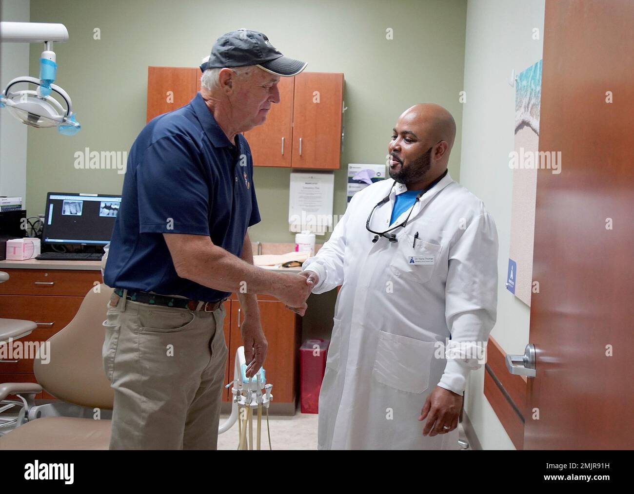 IMAGE DISTRIBUTED FOR ASPEN DENTAL - Dr. Travis Thompson shakes hands ...