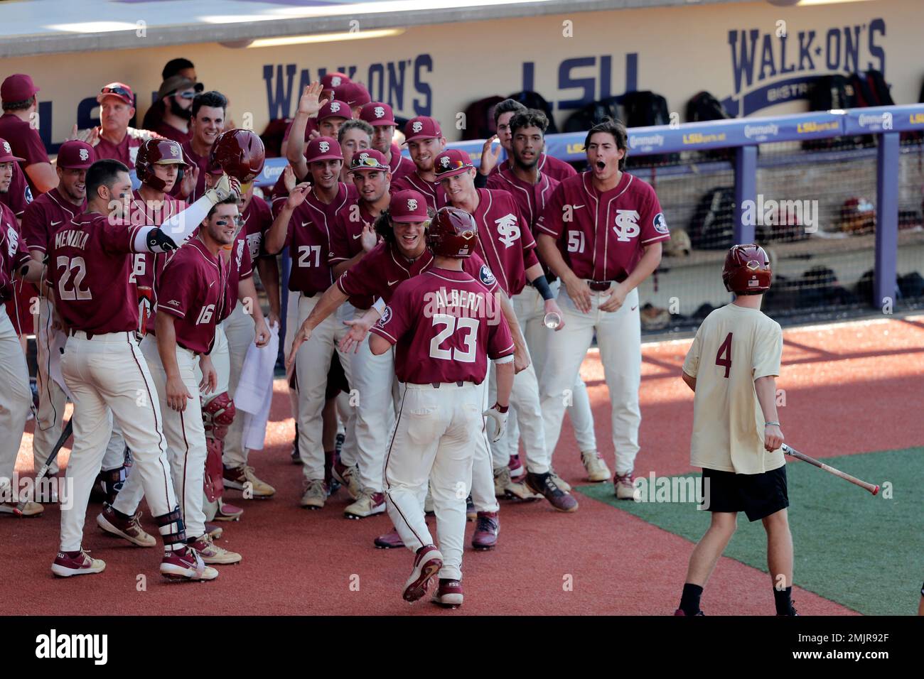 Florida State's Albert Reese is greeted at the dugout ofter his solo ...