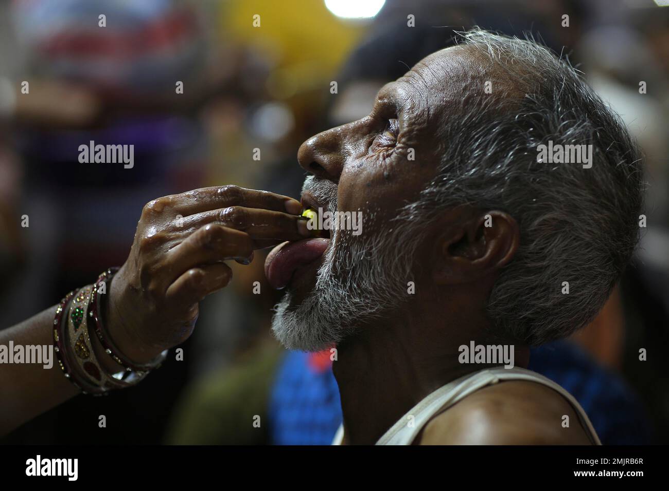 An Indian asthma patient is administered a traditional fish medicine in ...