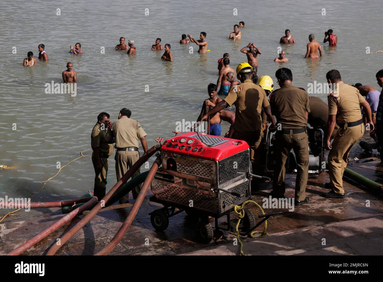 People take bath as firefighters set portable water pumps to fetch ...