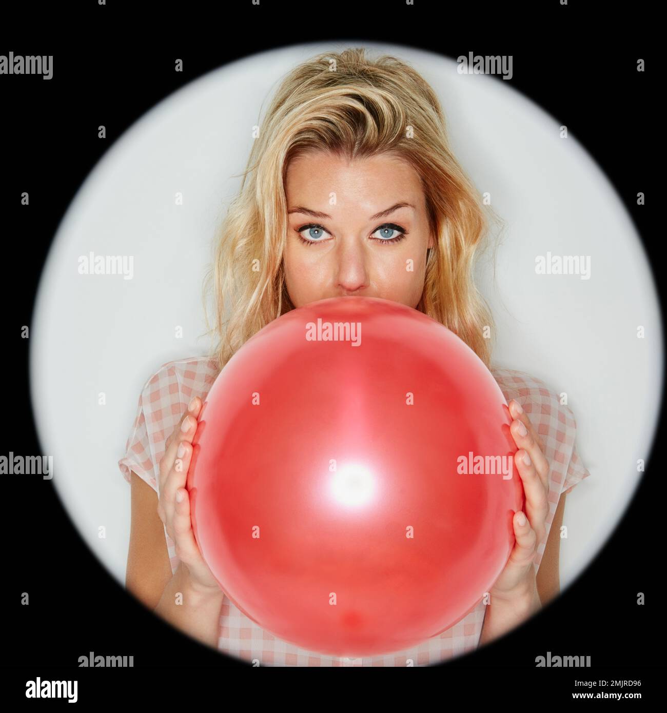 For the love of balloons. a beautiful young woman inflating a balloon ...