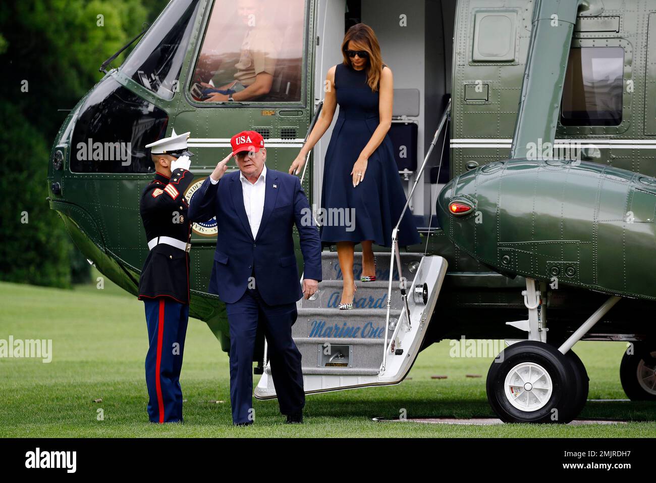President Donald Trump and first lady Melania Trump step off Marine One ...