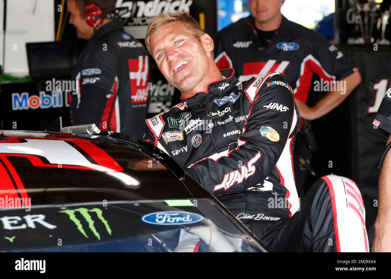 Clint Bowyer enters his car before practice for the NASCAR cup series ...