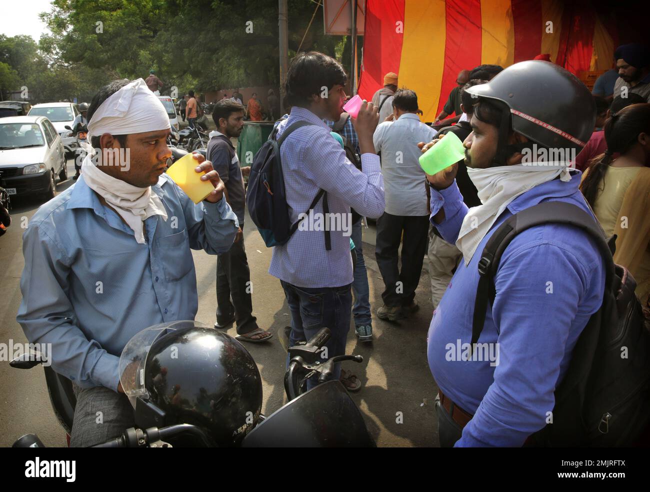 Commuters drink flavored water to beat the heat, in New Delhi, India ...