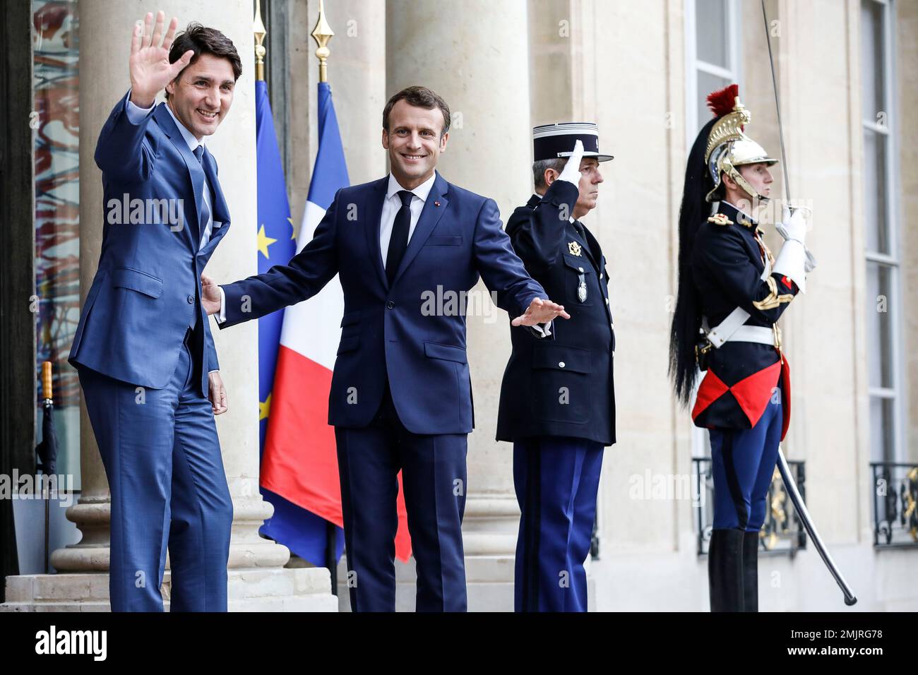 French President Emmanuel Macron, second left, greets Canada's Prime ...