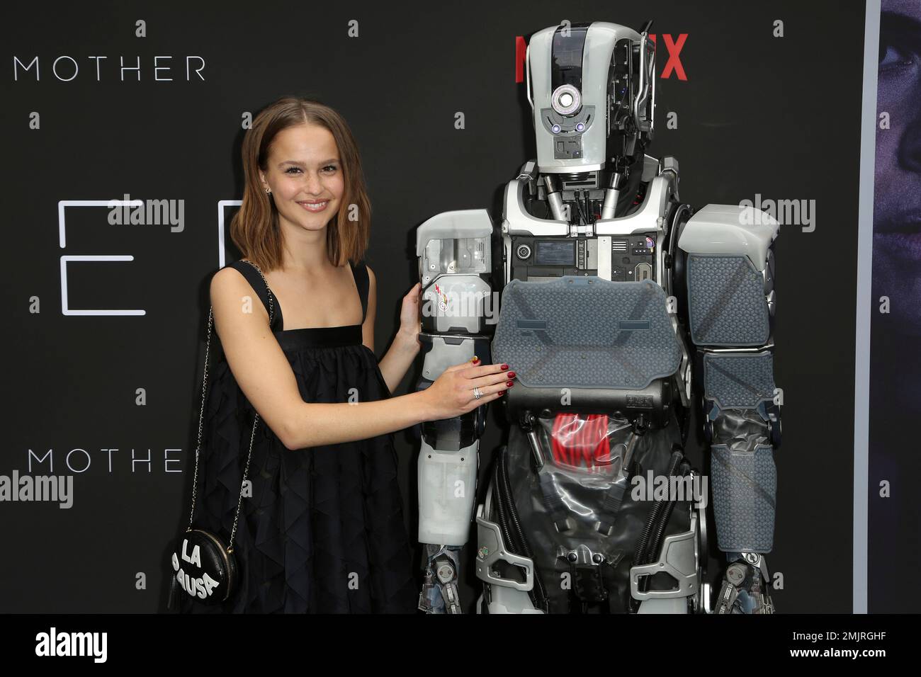 Clara Rugaard, left, poses with Mother the robot at the LA Special ...