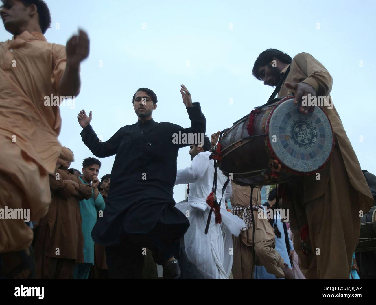 People perform a traditional dance to celebrate the second day of Eid ...