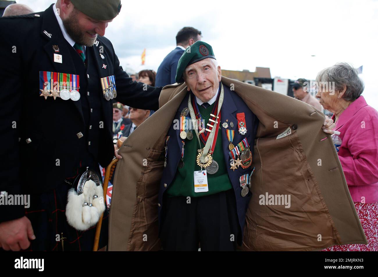 British D-Day veteran Harry Billinge opens his coat to show his medals ...