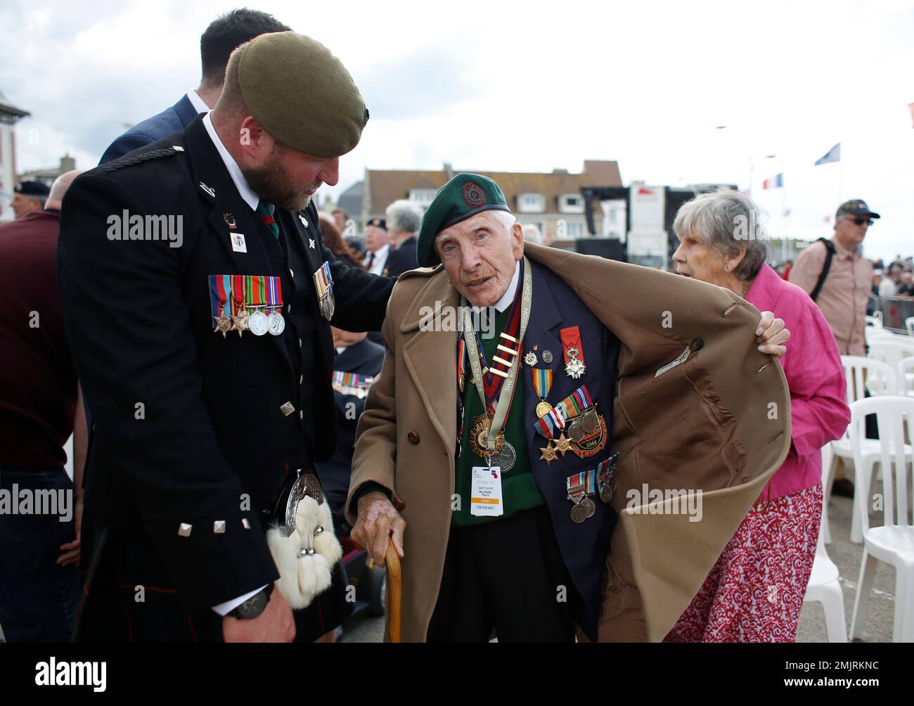 British D-Day veteran Harry Billinge opens his coat to show his medals ...