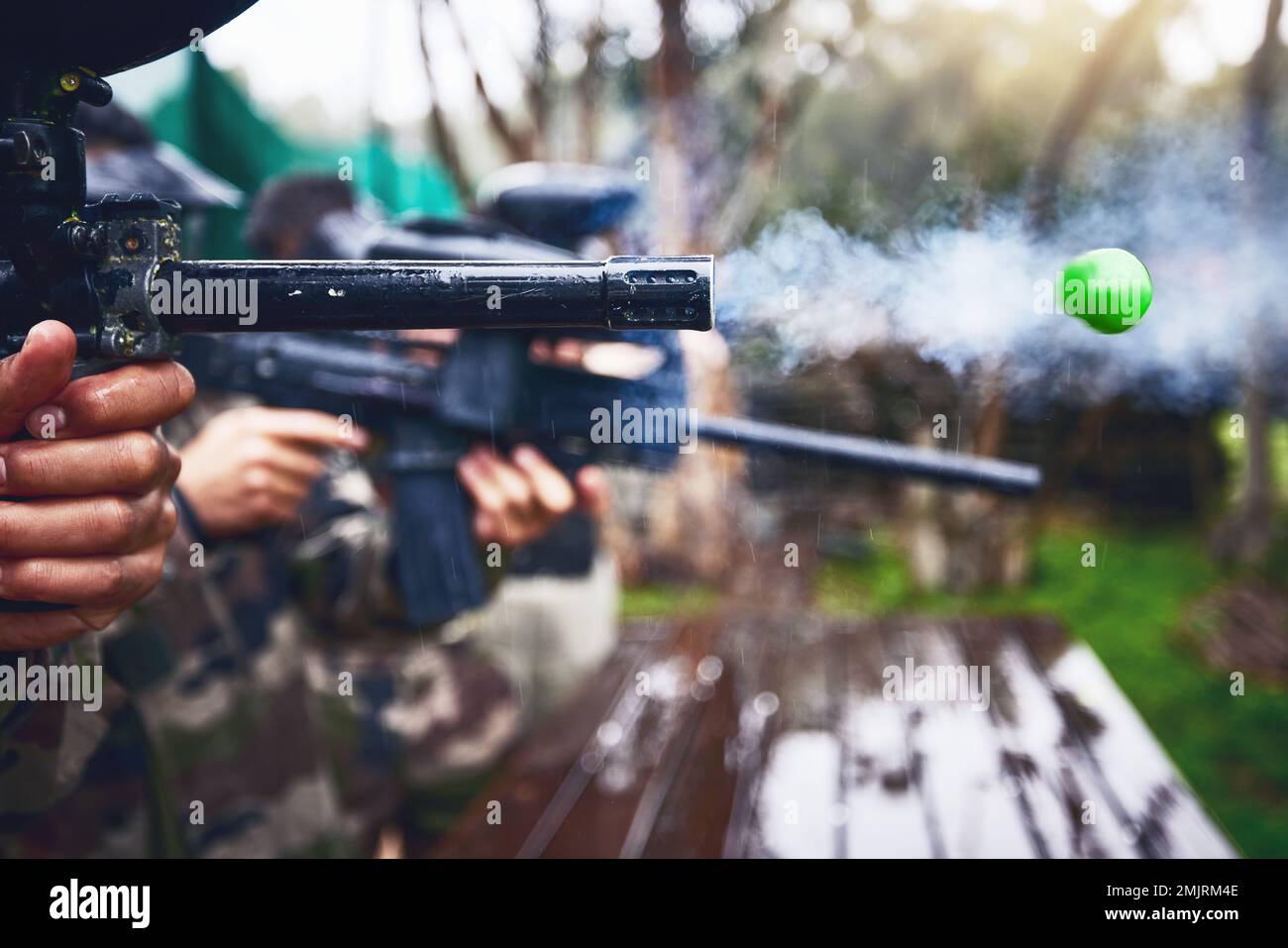 Explosion, shooting and person with paintball gun, ball and closeup of ...
