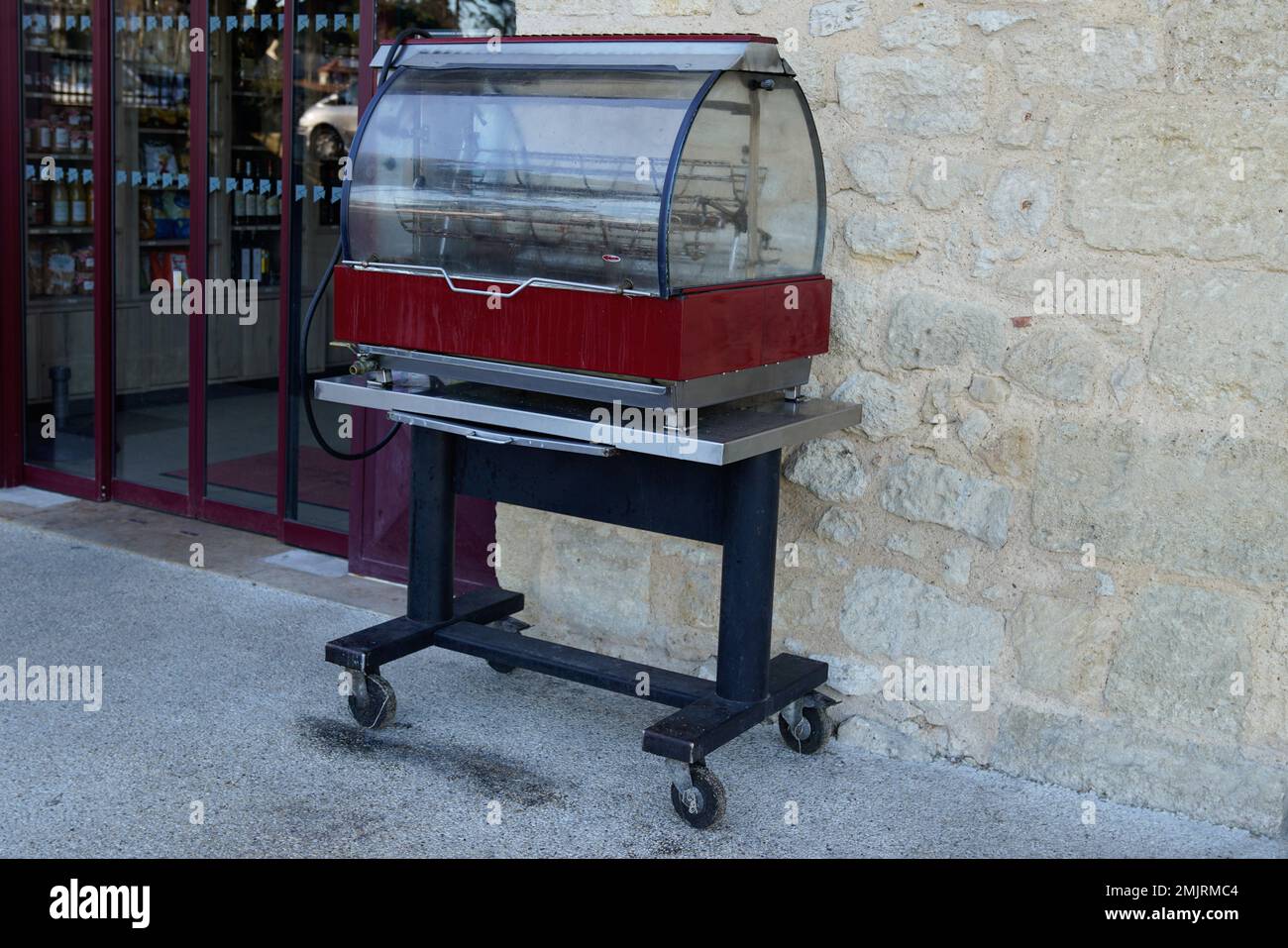 Roast machine oven or outdoor rotisserie in a row in a butcher roaster ...