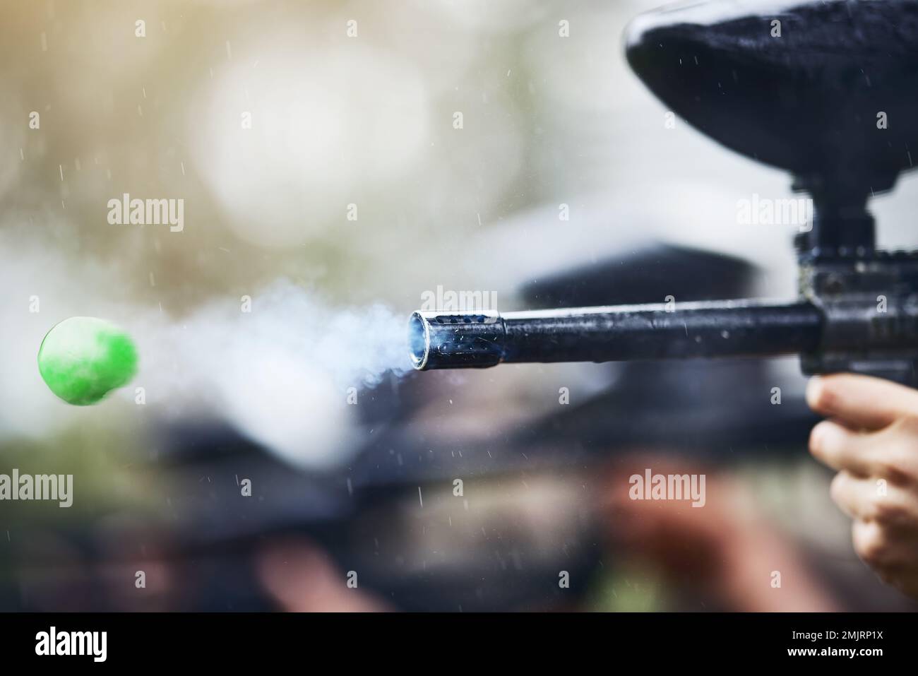Gun, paintball and ball closeup with person shooting for fun, extreme ...