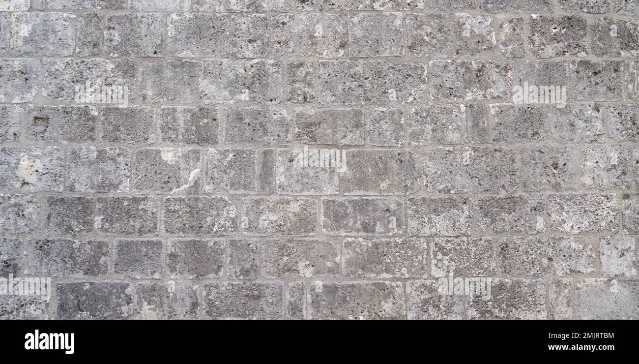old gray cement background with old brick bricks Stock Photo - Alamy
