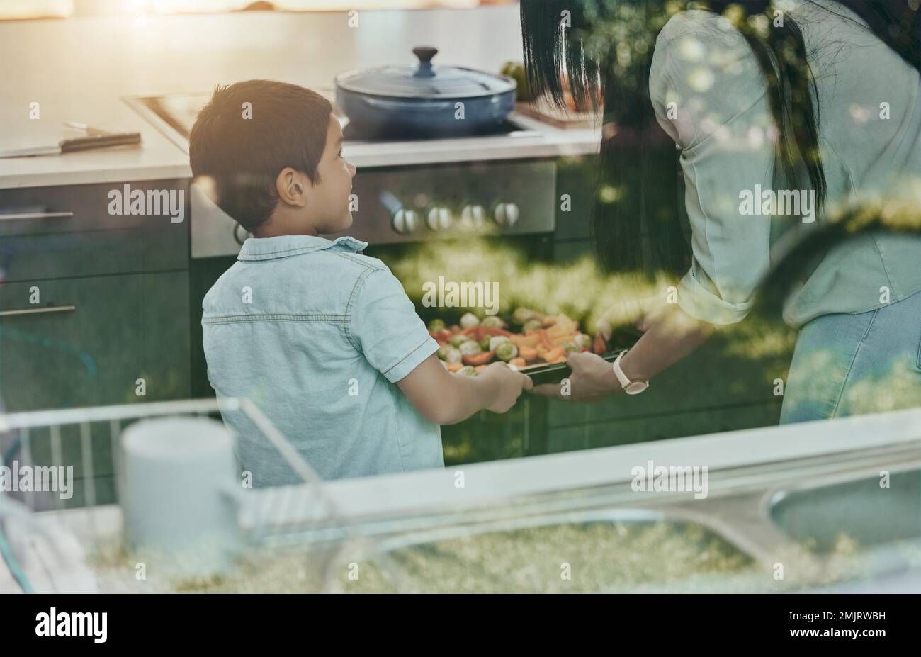 Cooking, vegetables and child helping mother with food, preparation and ...