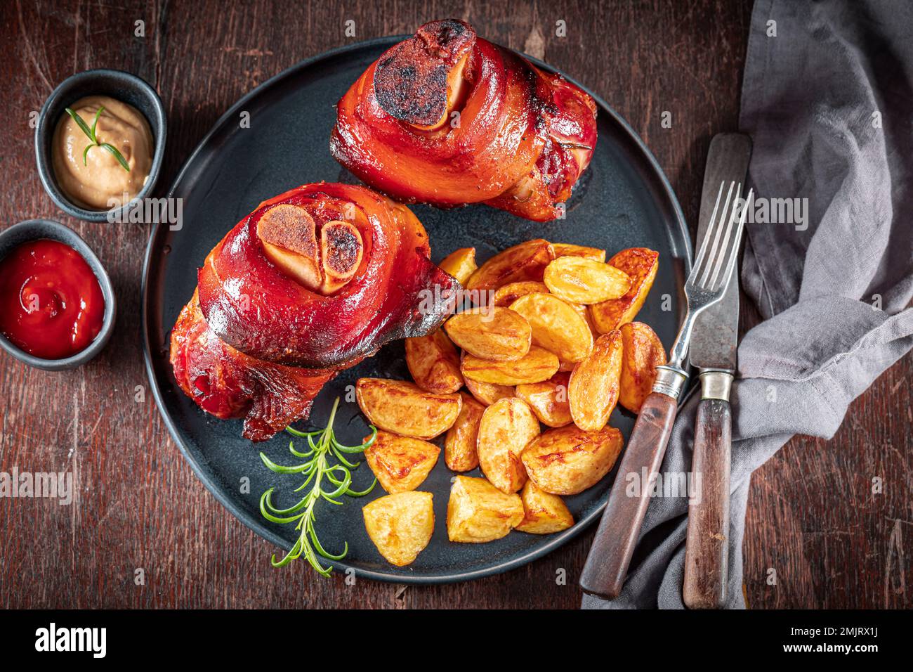 Cripsy grilled ham hock served with fries and ketchup. Roasted pork ...