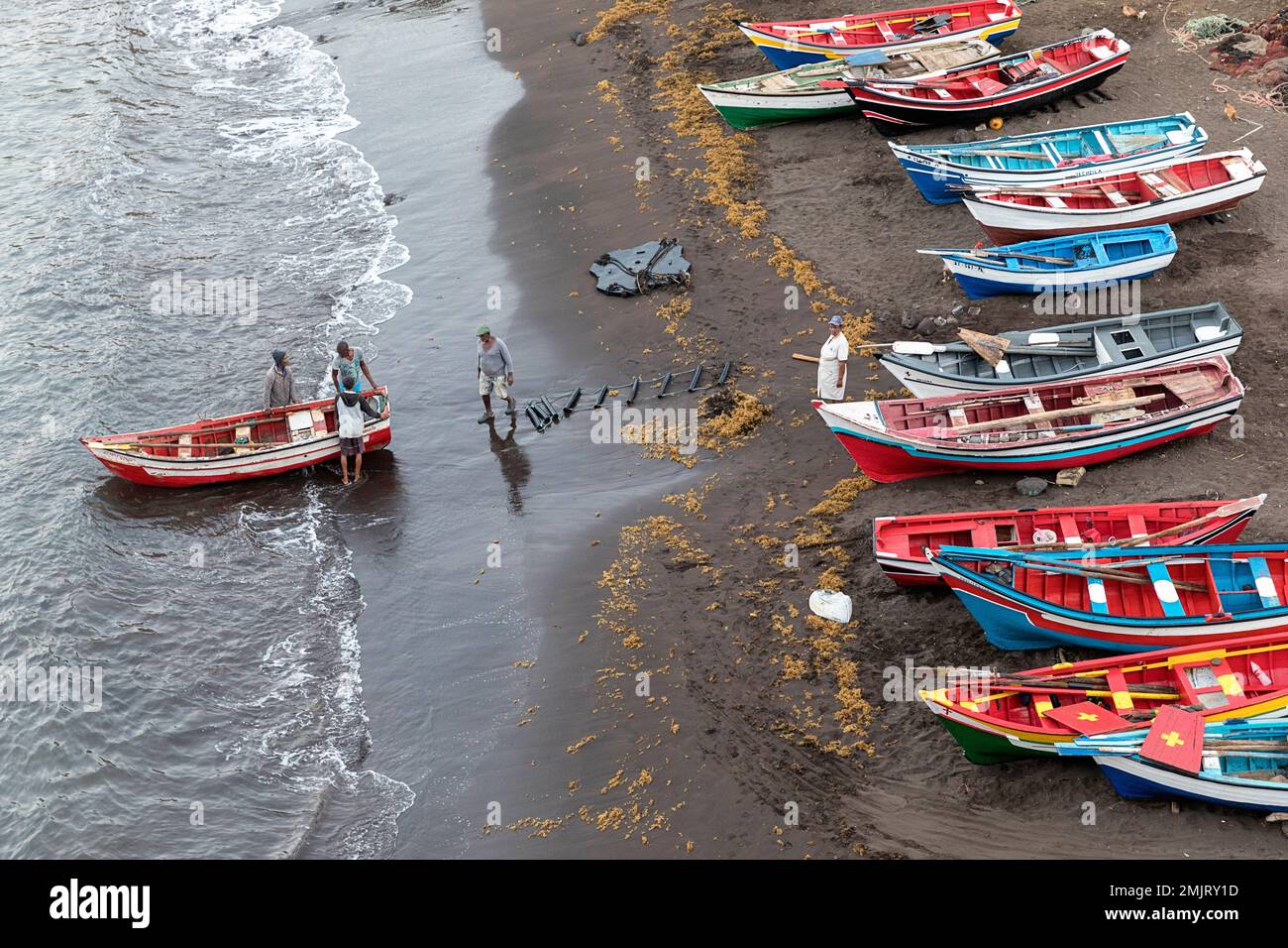 Local fishermen preparing traditional fishing wooden boat at the beach ...