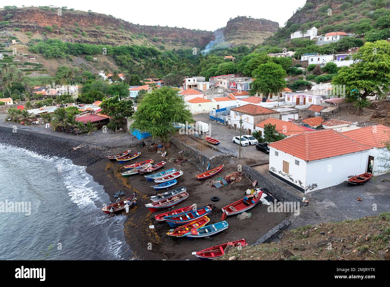 Local fishermen launching traditional fishing wooden boat in the sea at ...