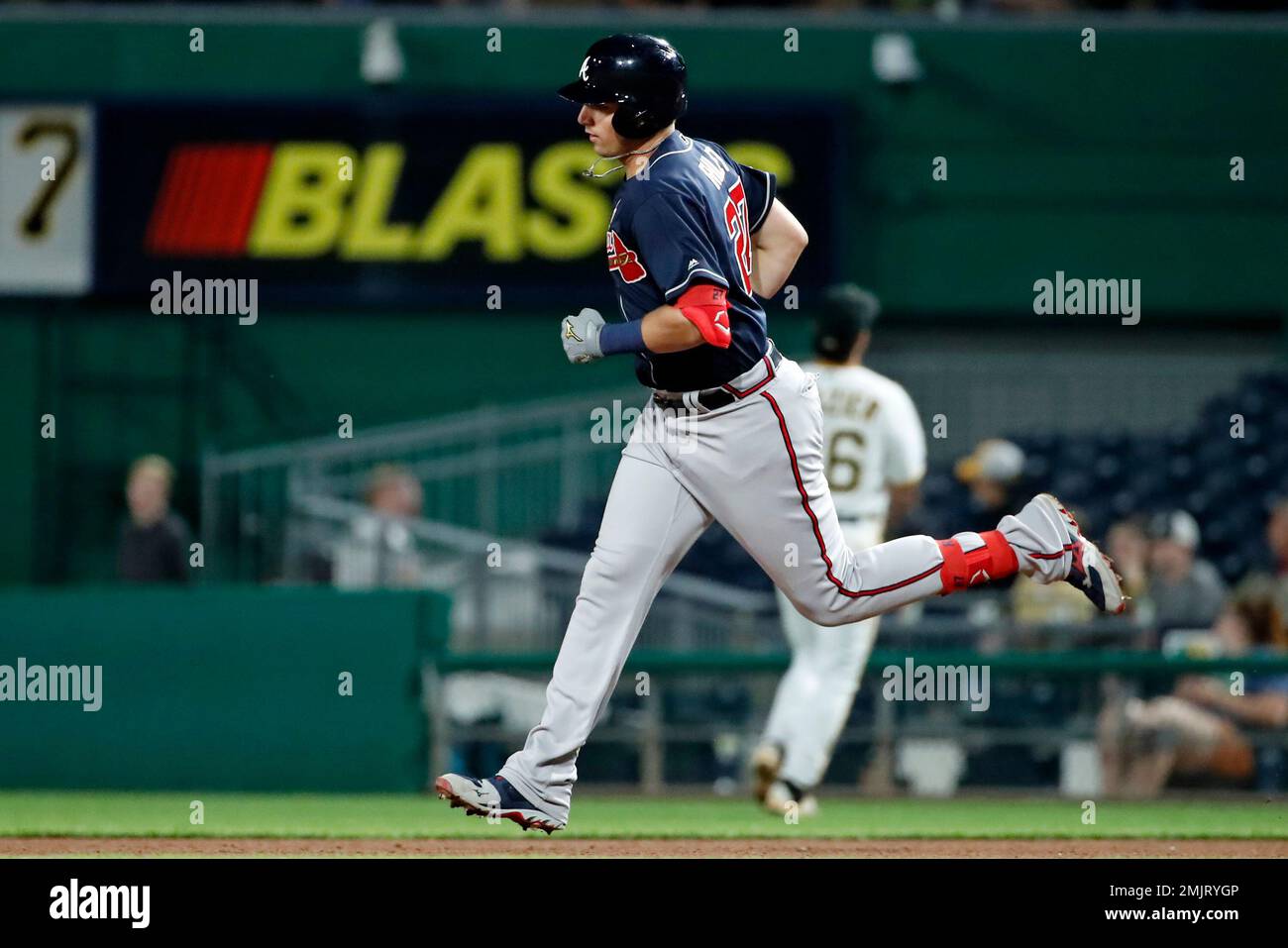 Atlanta Braves' Austin Riley, right, rounds first after hitting a three ...