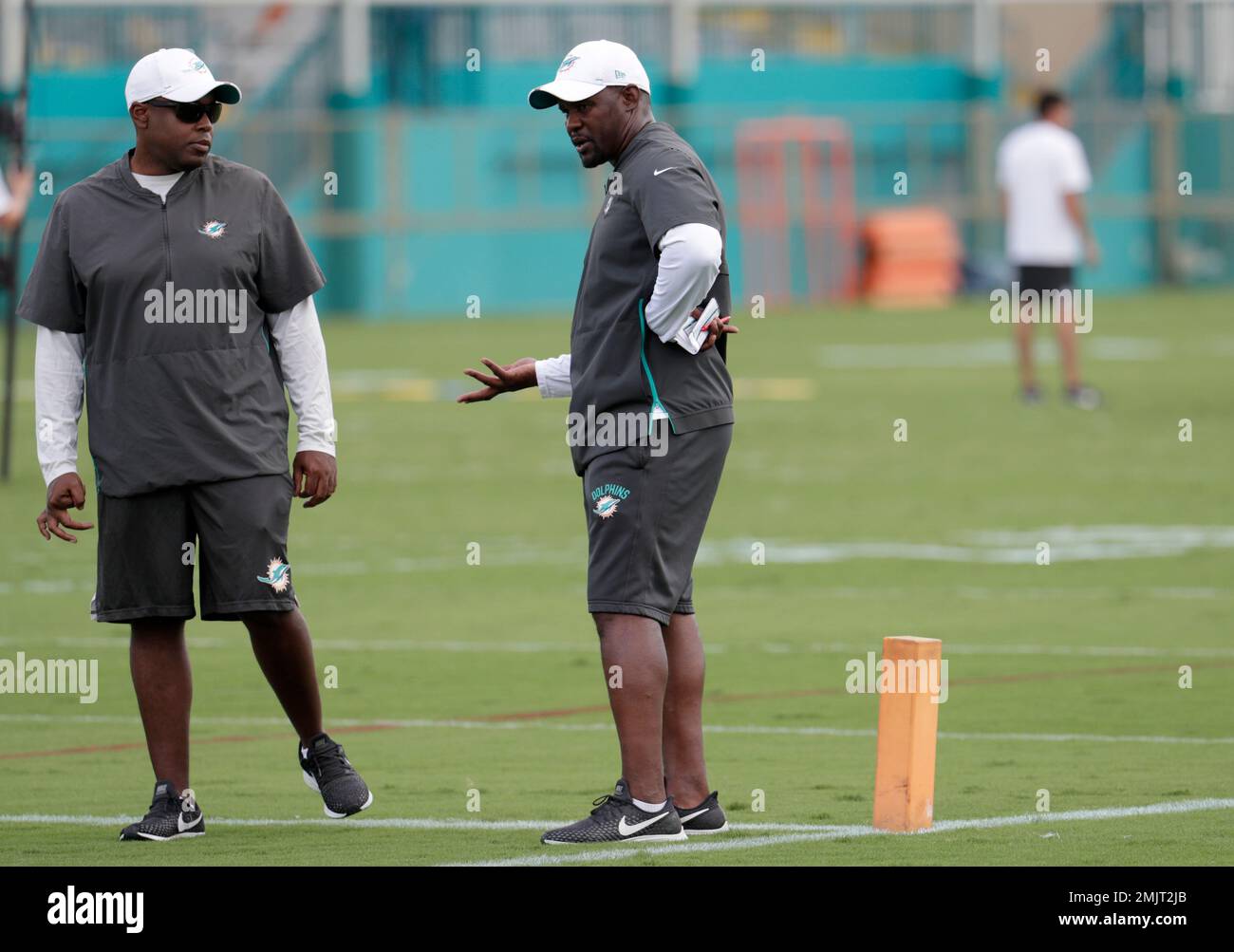 Miami Dolphins general manager Chris Grier, left, talks with head coach ...