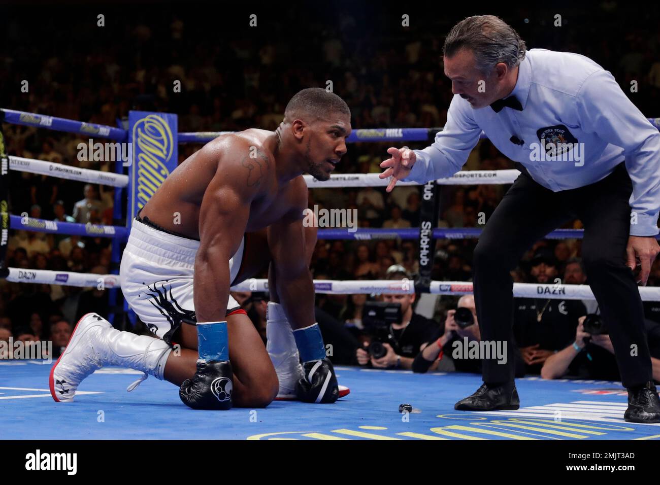 British boxer Anthony Joshua reacts as the referee counts for him after ...