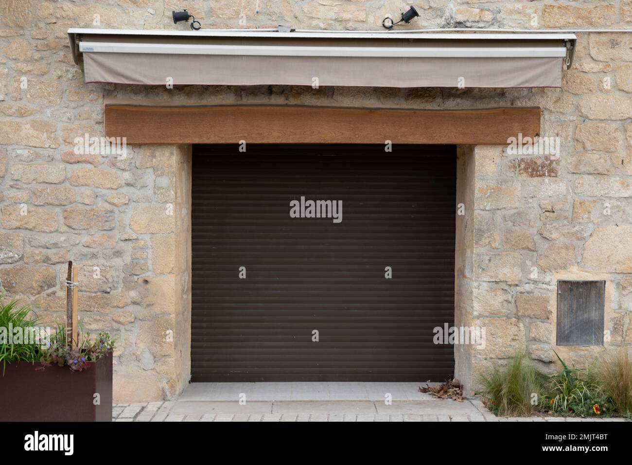 store closed by brown roller shutter for holidays or permanent closure ...