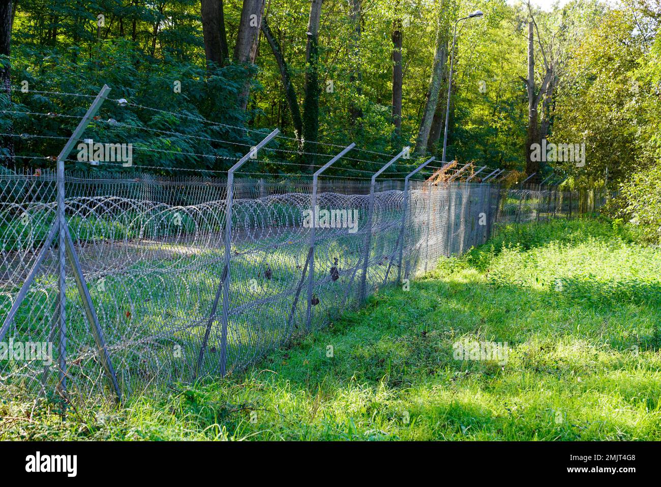 fence wall and barbed wire barrier as a secret private place or ...
