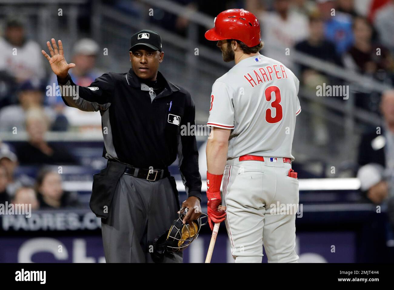 Philadelphia Phillies' Bryce Harper (3) talks with home plate umpire ...
