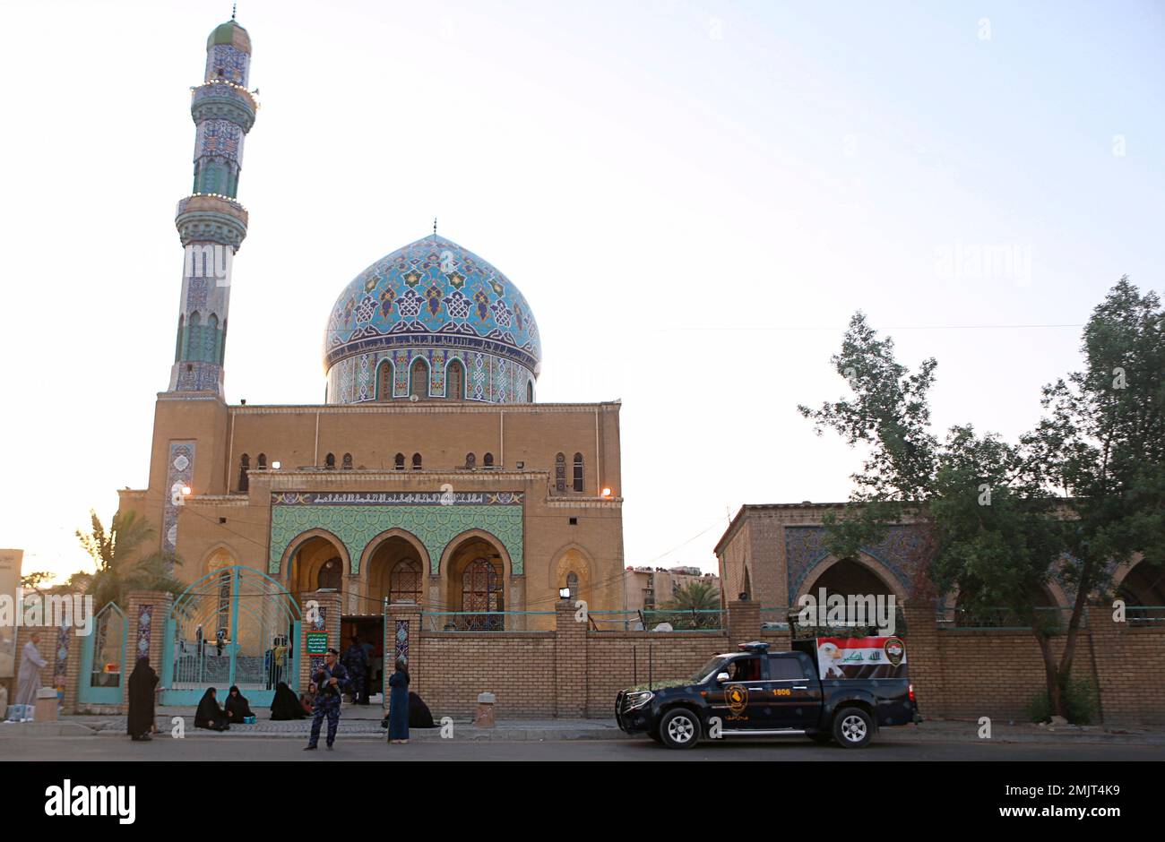 Security forces stand guard outside the 17th of Ramadan mosque as ...