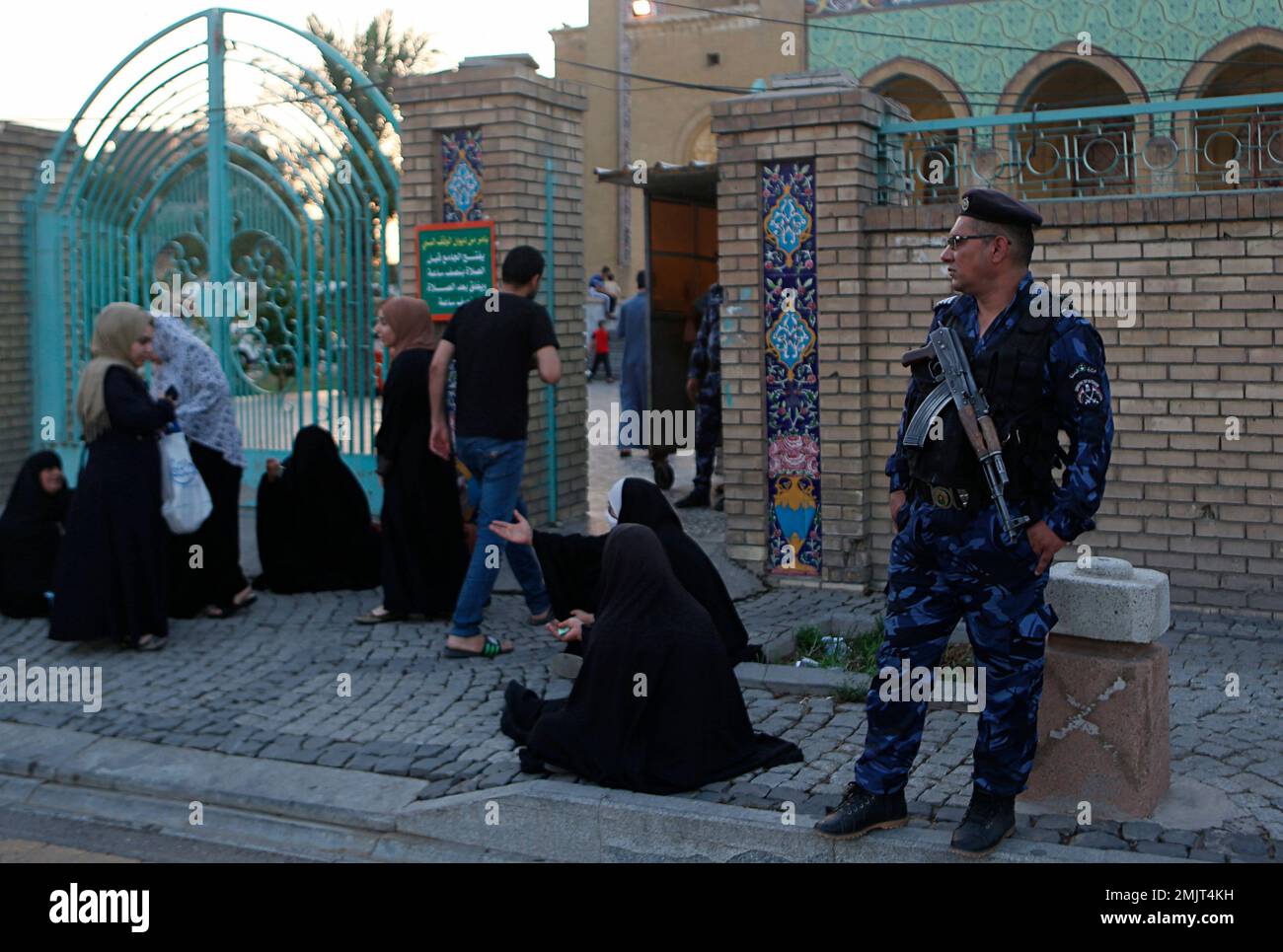 Security forces stand guard outside the 17th of Ramadan mosque as ...