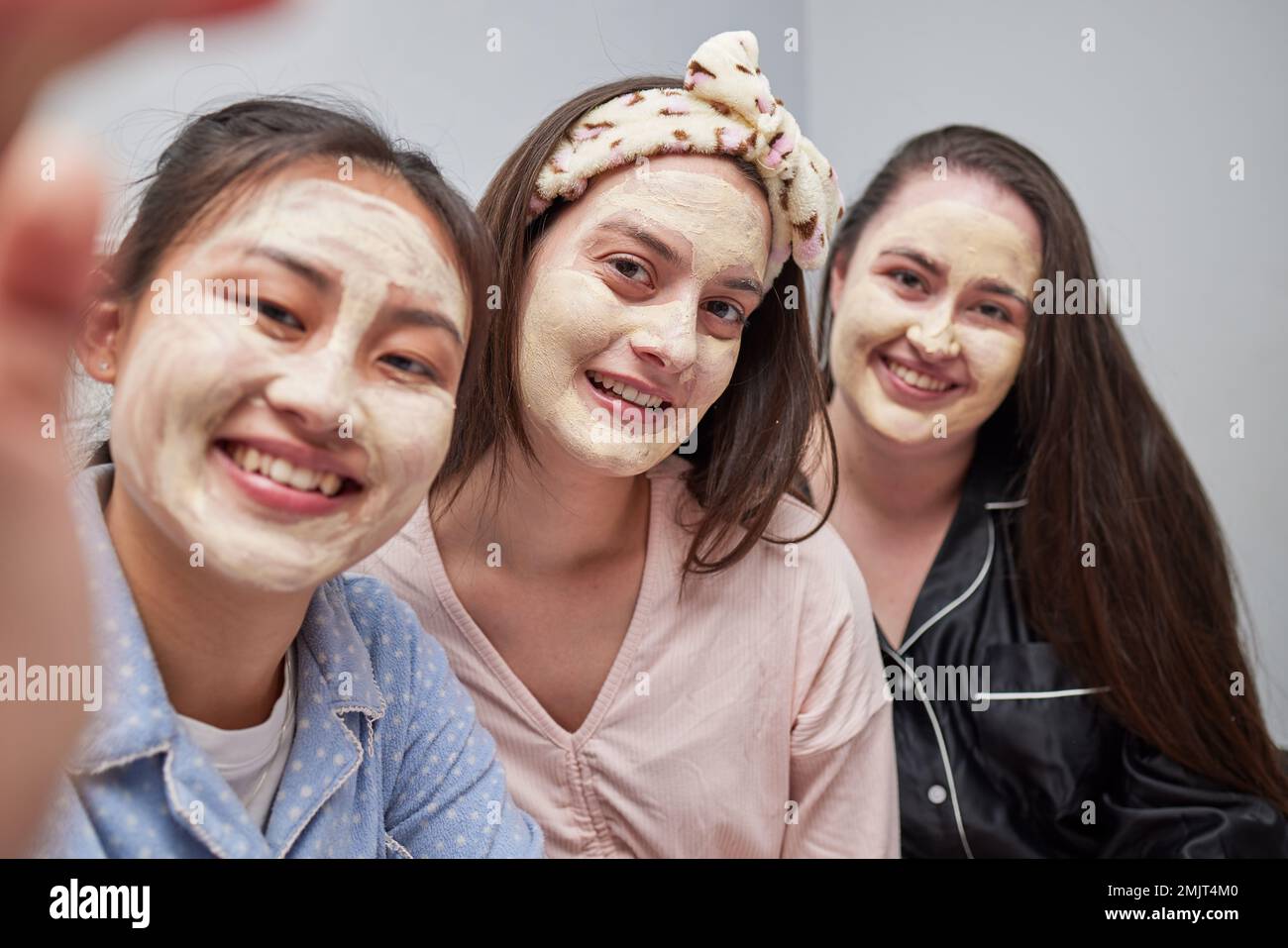Friends, women and sleepover with mask, selfie and bonding with ...