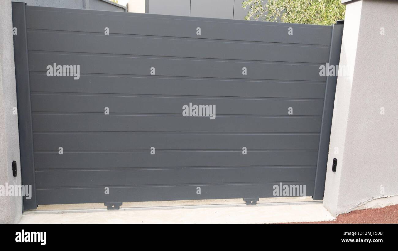 modern grey sliding gate aluminum portal of home Stock Photo - Alamy