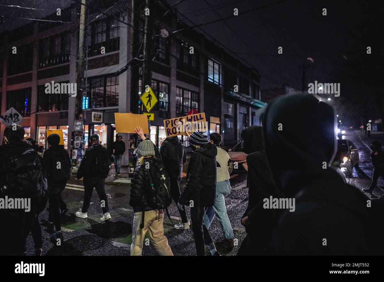 Protesters march through the streets while holding placards during the ...