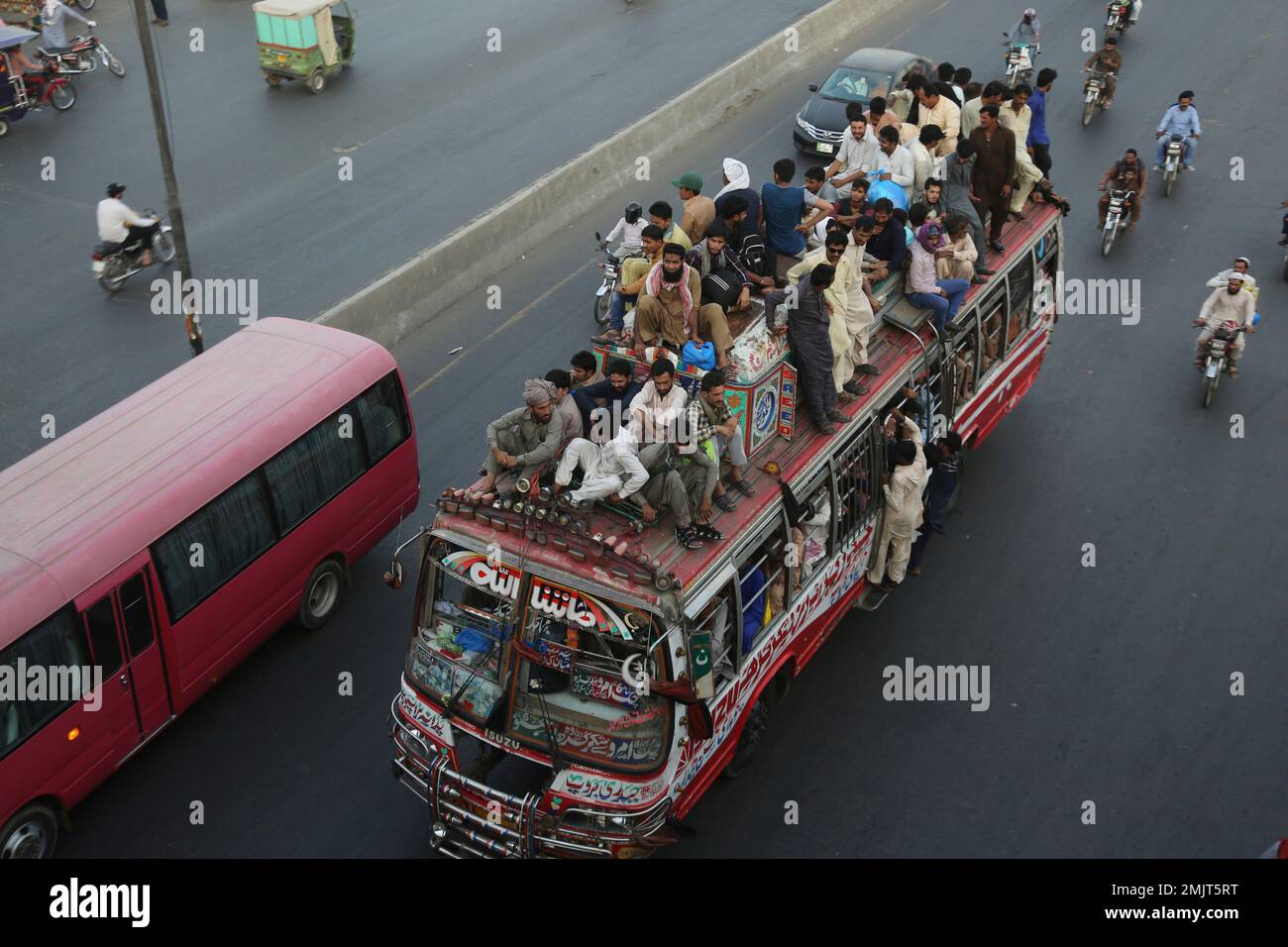 Pakistani passengers ride on crowded bus to their hometown and villages ...