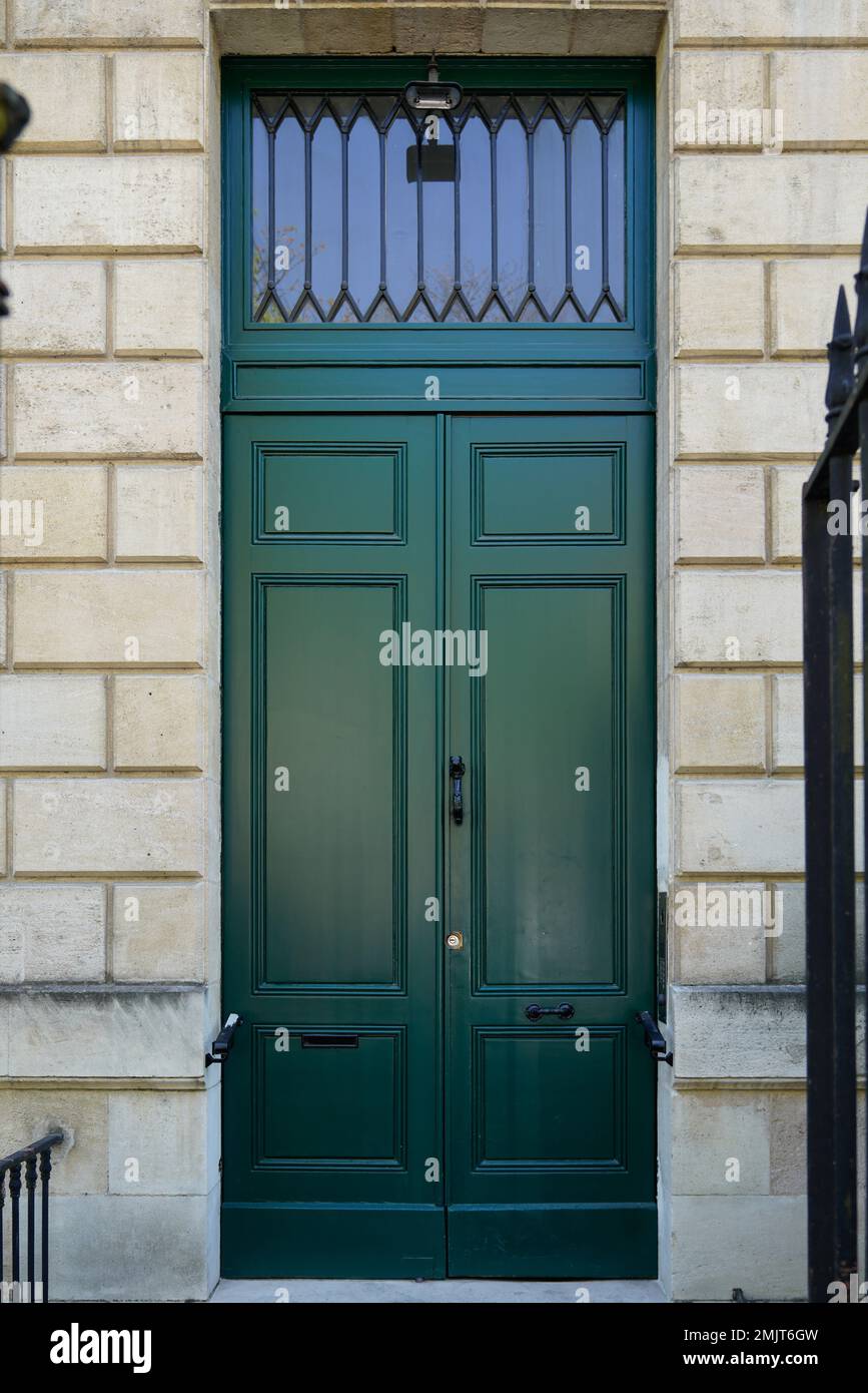Wooden high door green on french wall entrance city street classic ...