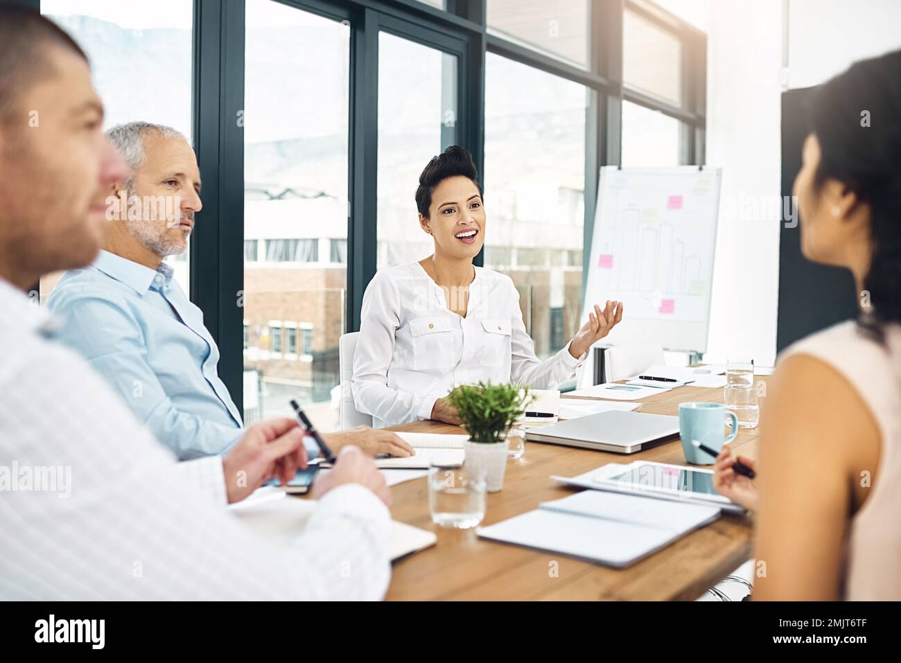 Making success look easy. a group of coworkers talking together in a ...